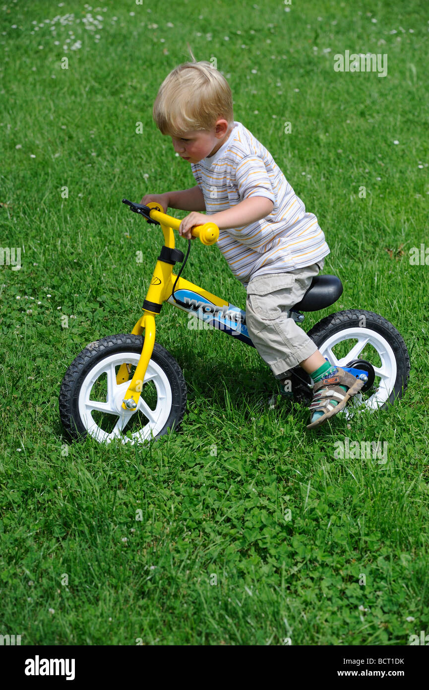 Little child boy riding a bounce bicycle with bike helmet Stock Photo ...