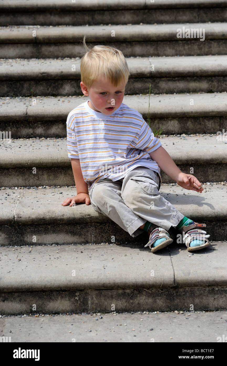 Little Blond Boy Sitting on Steps Stock Photo - Alamy