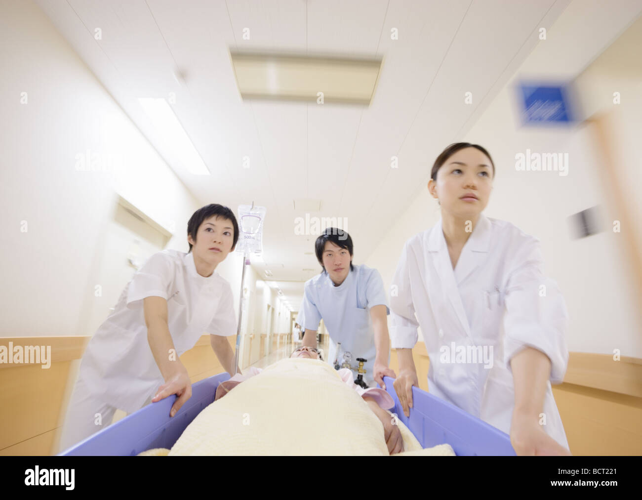 Doctor and nurse carrying patient Stock Photo - Alamy