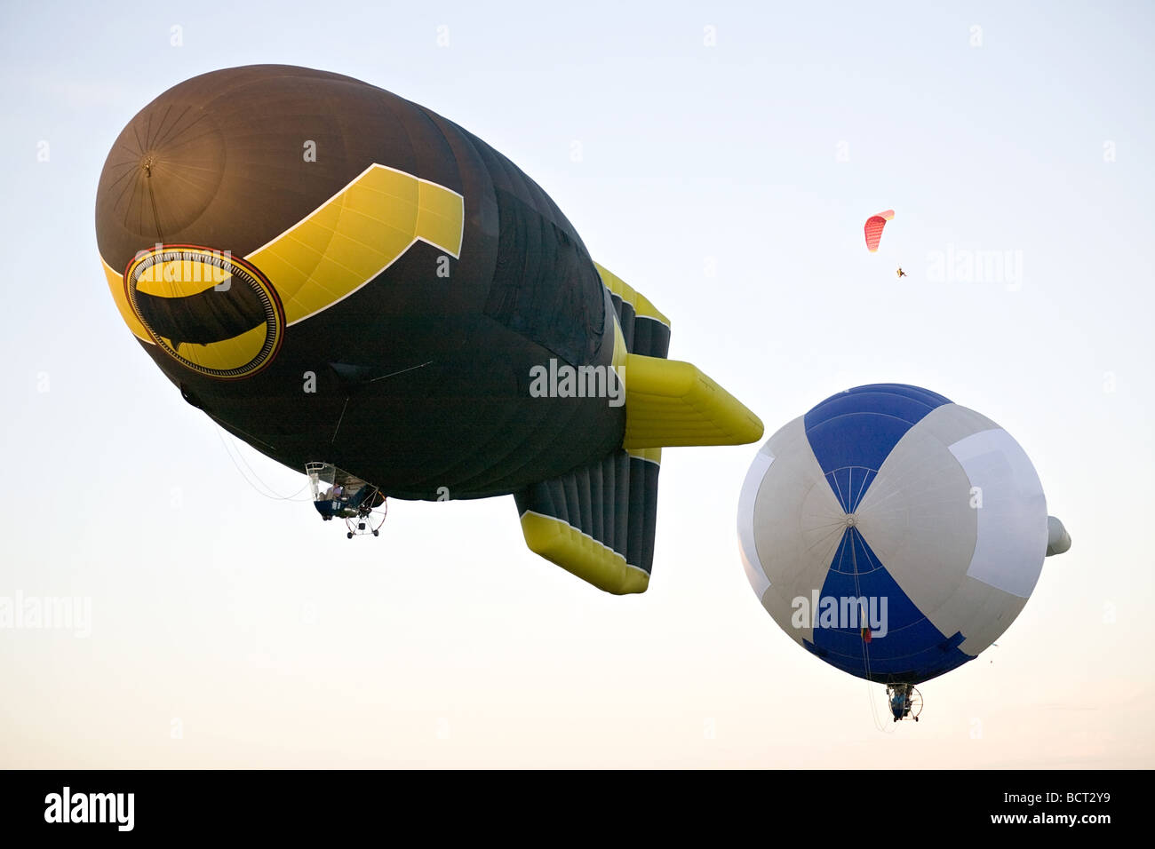 two flying dirigibles on clear blue sky background Stock Photo - Alamy