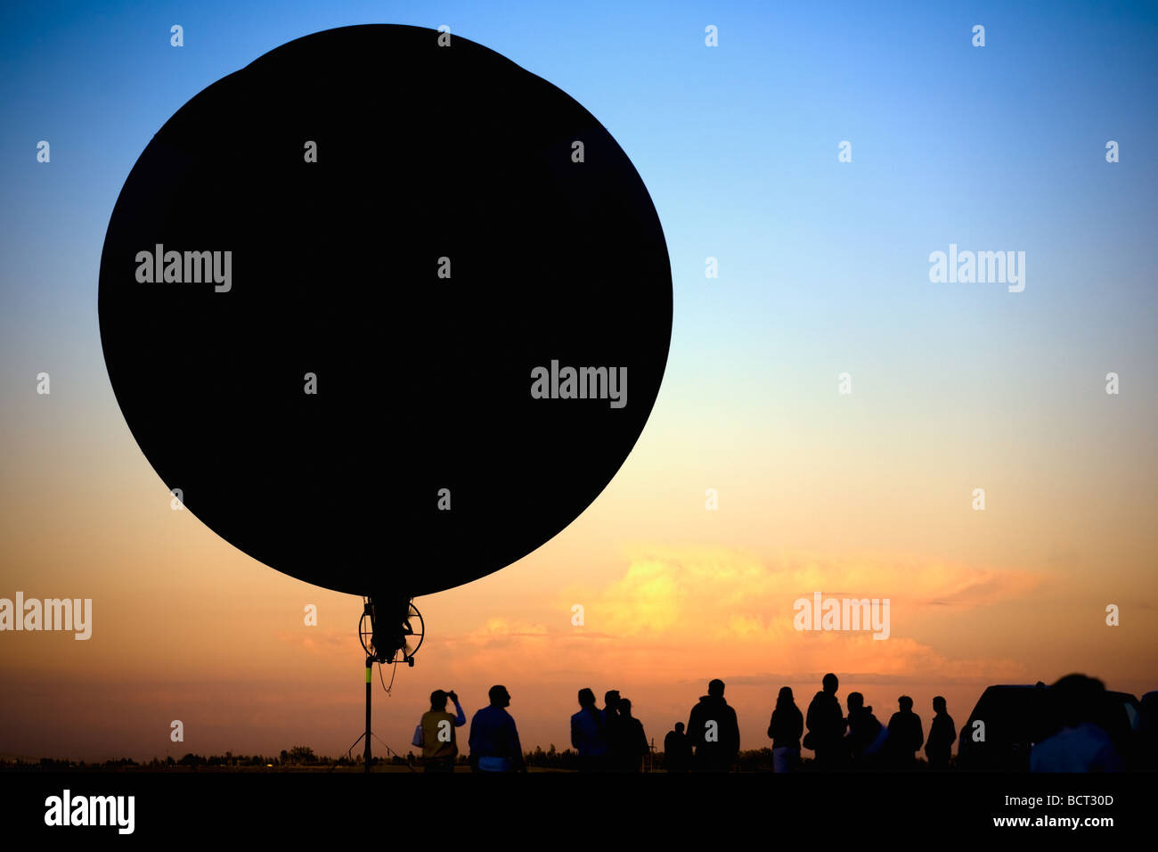 flying blimp silhouette on colorful sunset background Stock Photo - Alamy