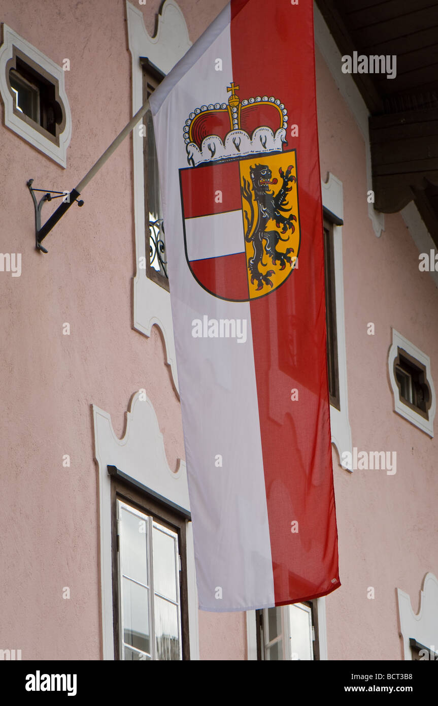Austrian flag with coat of arms on flag pole outside a civil building ...