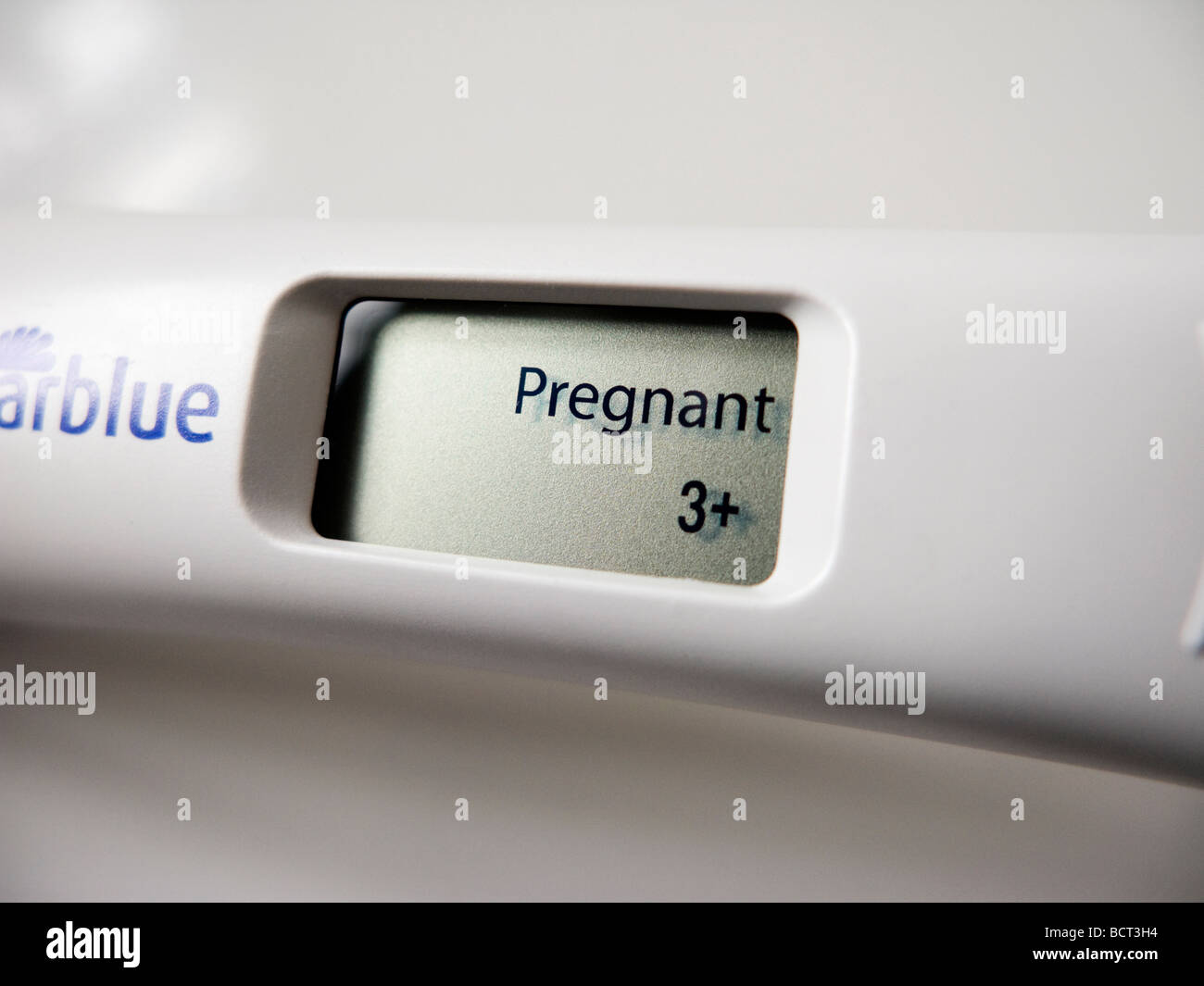 A pregnancy test device showing a positive pregnant result on the LCD ...