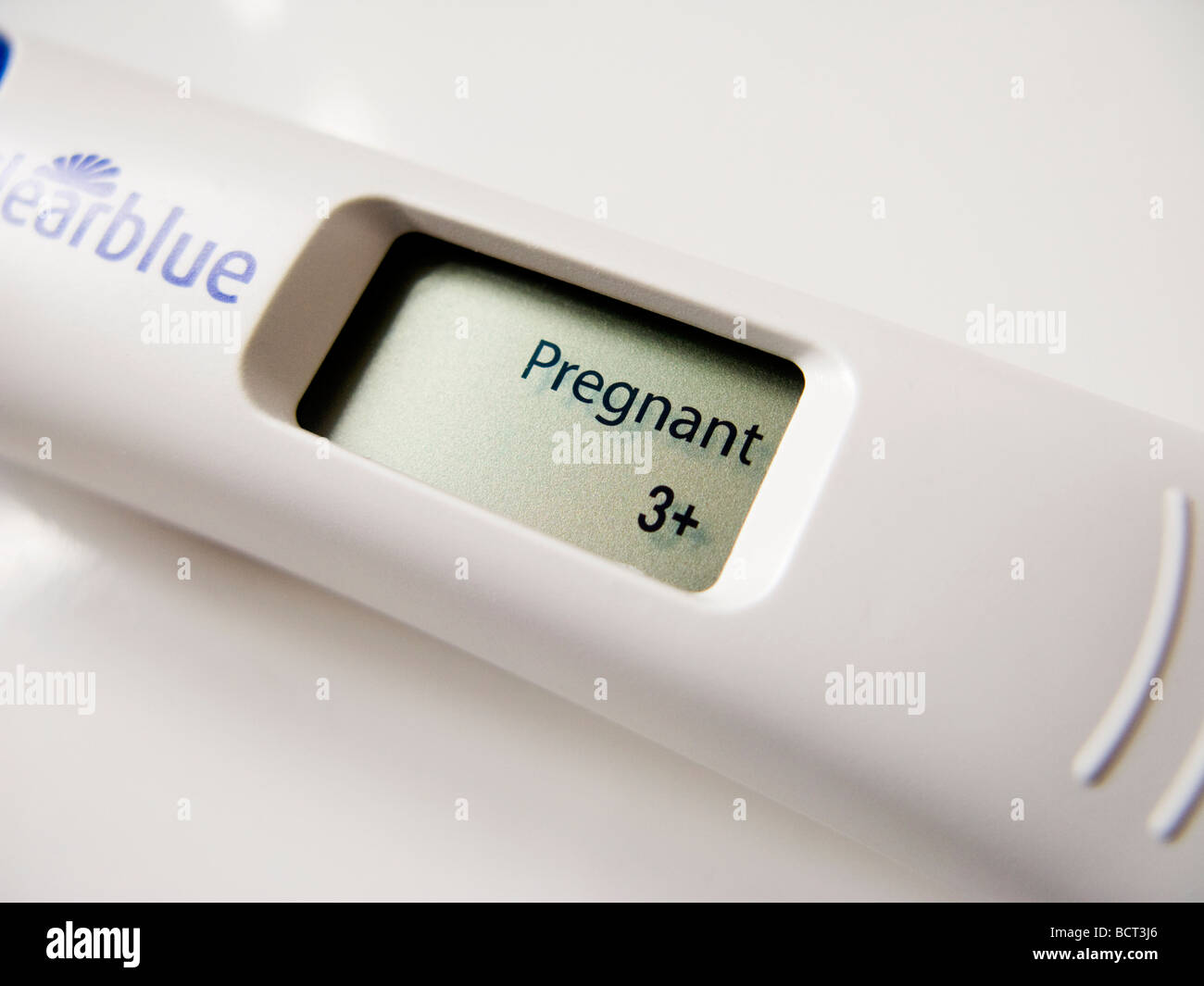 A pregnancy test device showing a positive pregnant result on the LCD ...