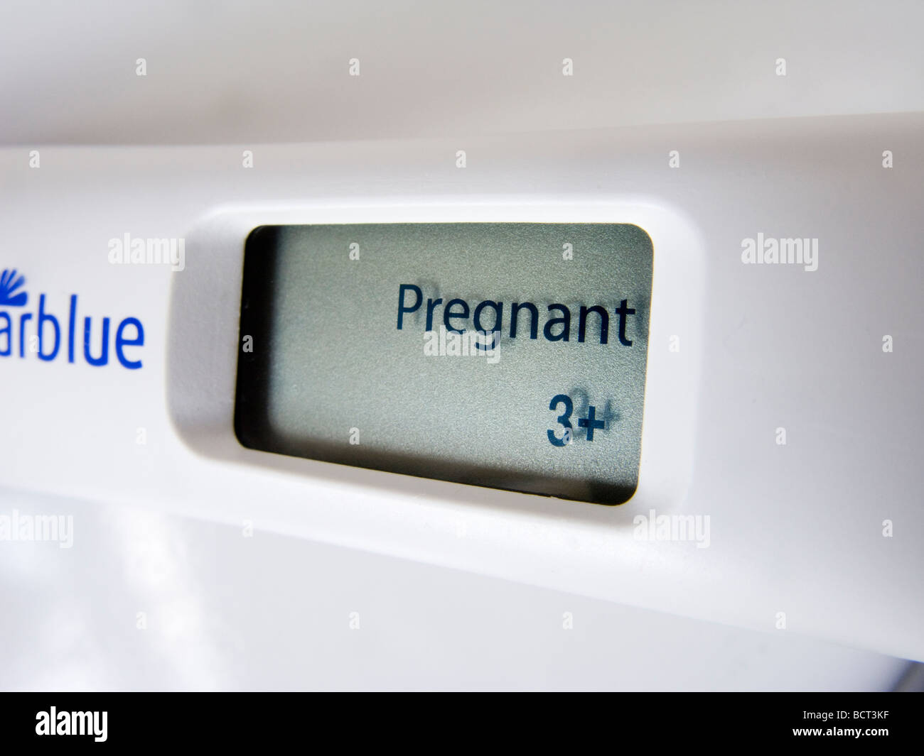A pregnancy test device showing a positive pregnant result on the LCD ...