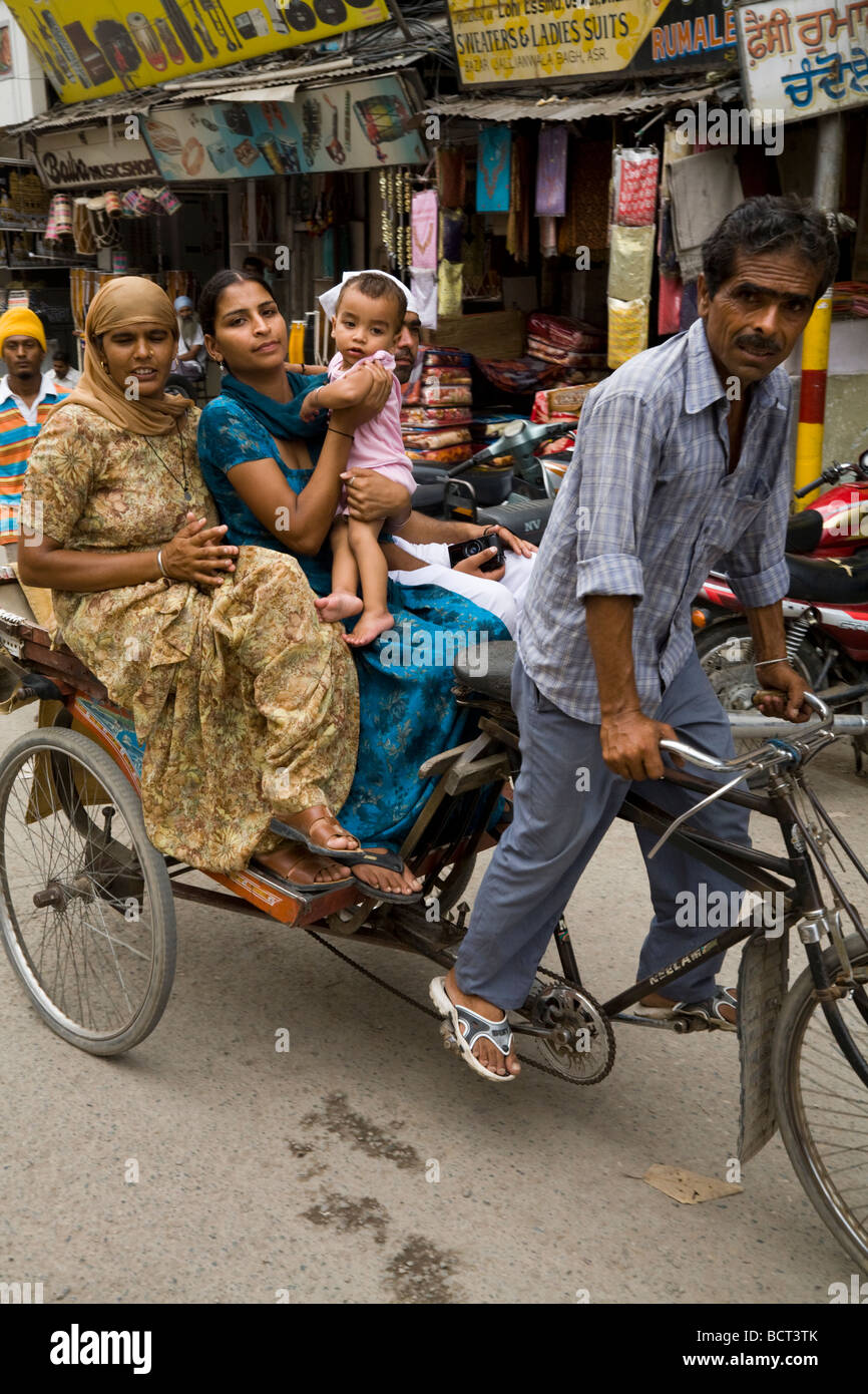 Indian woman and a baby / toddler taking a journey by cycle rickshaw ...