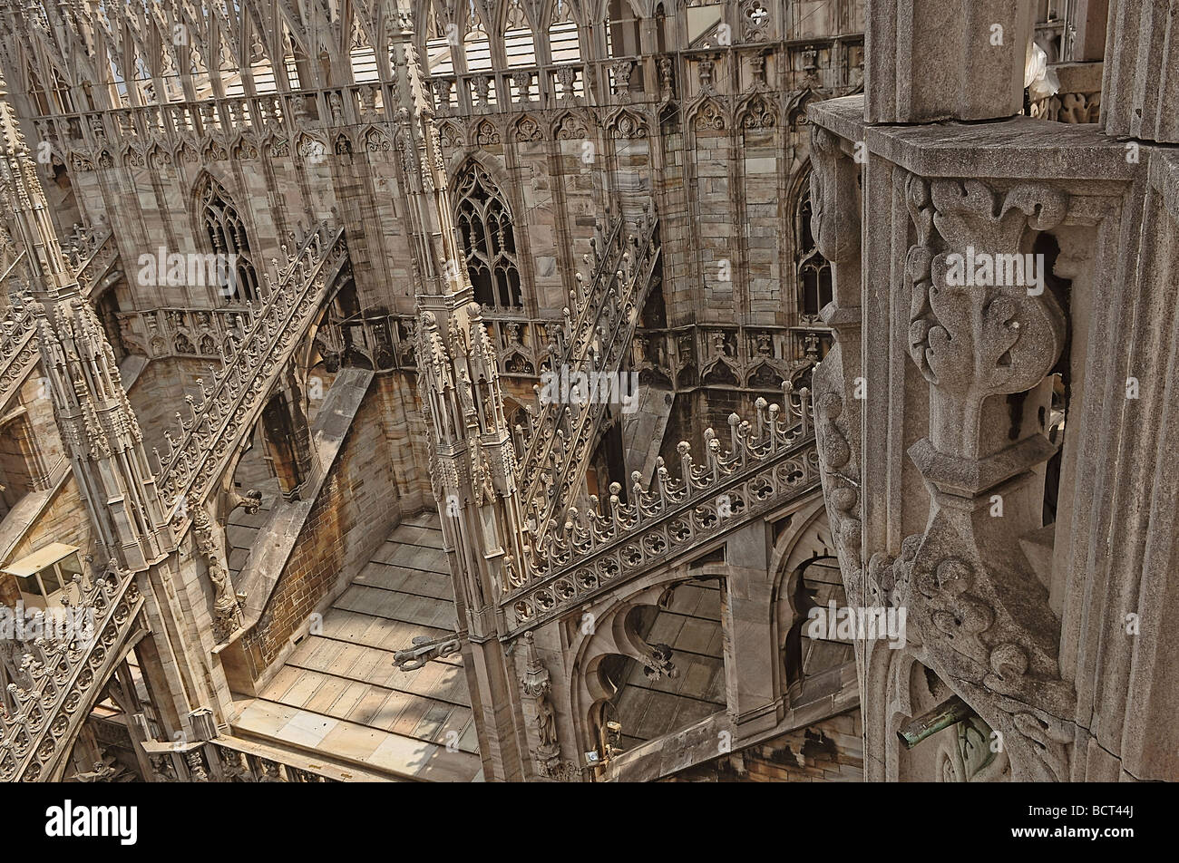 Milan cathedral with balcony, flying buttresses, and church spires ...
