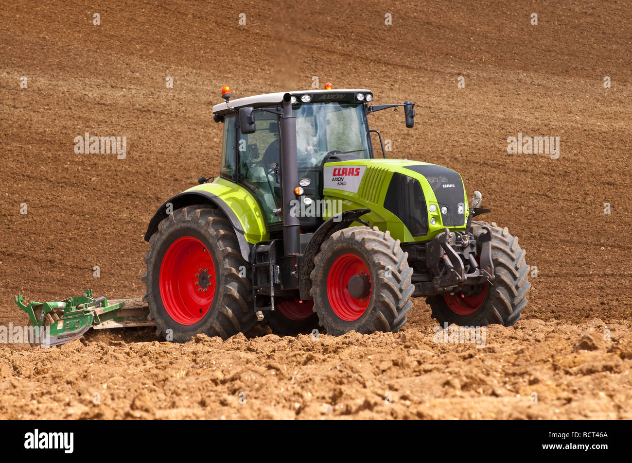 Claas Axion 820 tractor harrowing plowed field, sud-Touraine, France ...