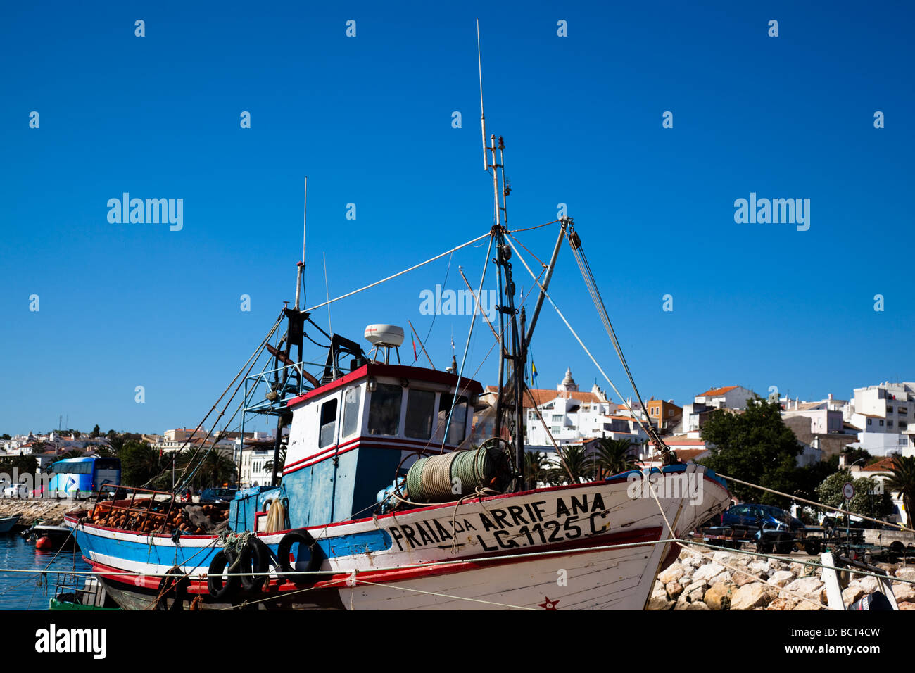 Colourful Portuguese fishing boats in the harbour of Lagos, Portugal ...