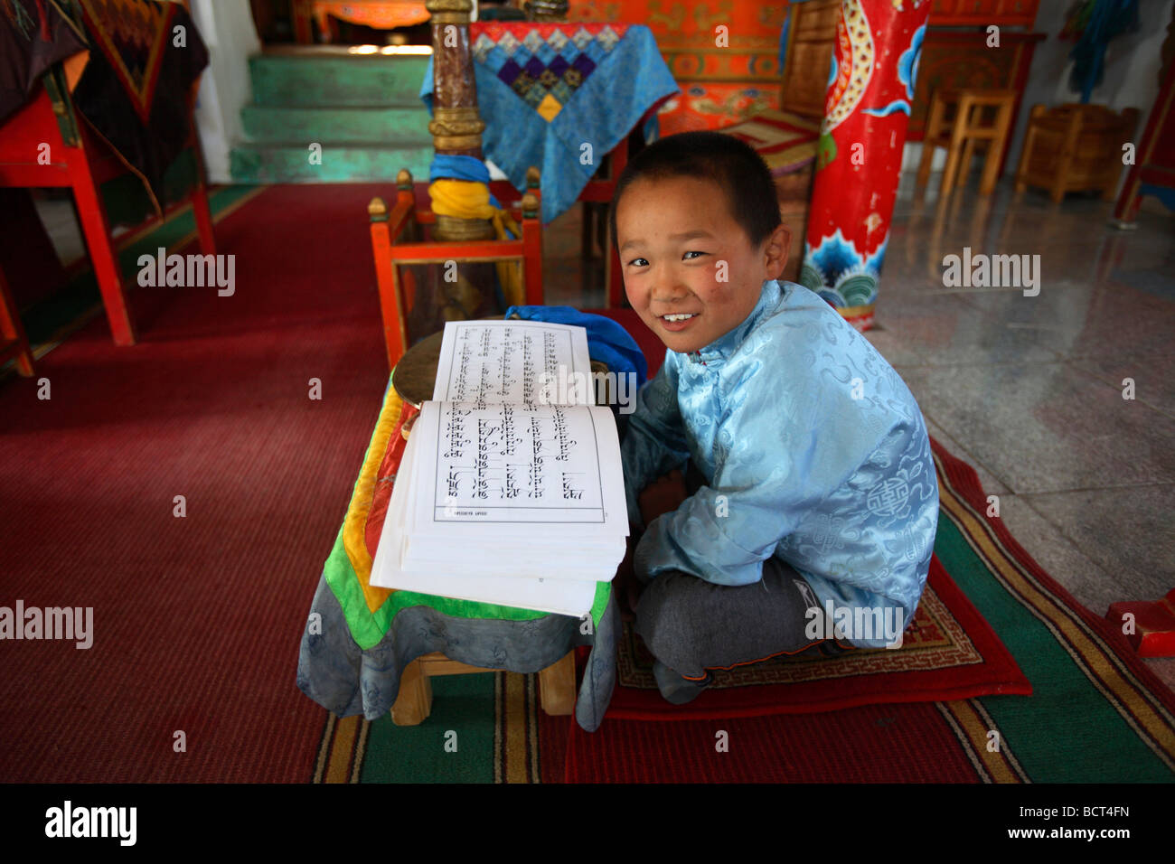Child monk reading a pray book , Mongolia Stock Photo - Alamy