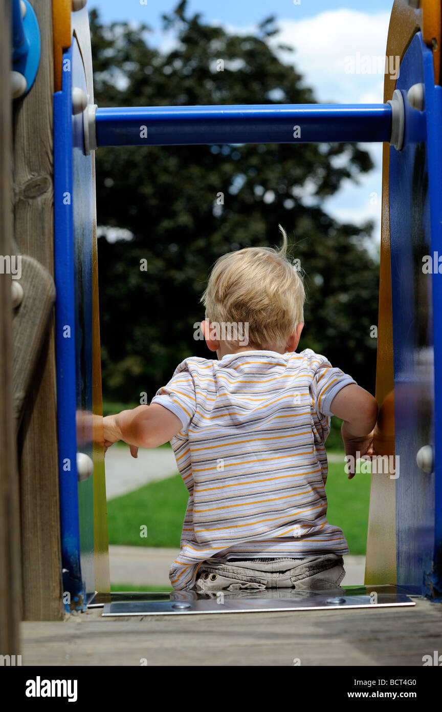 Child blonde boy sliding down the slide on the playground Stock Photo ...