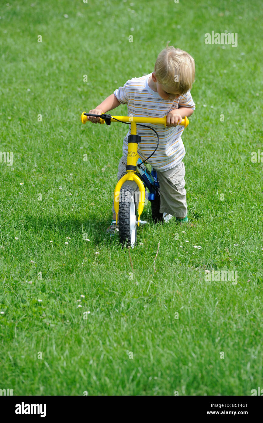 Little child boy riding a bounce bicycle with bike helmet Stock Photo ...