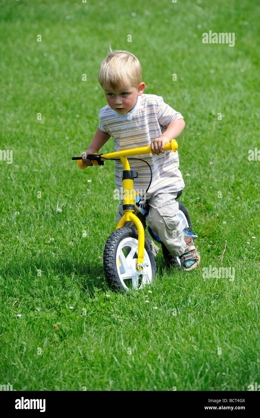 Little child boy riding a bounce bicycle with bike helmet Stock Photo ...