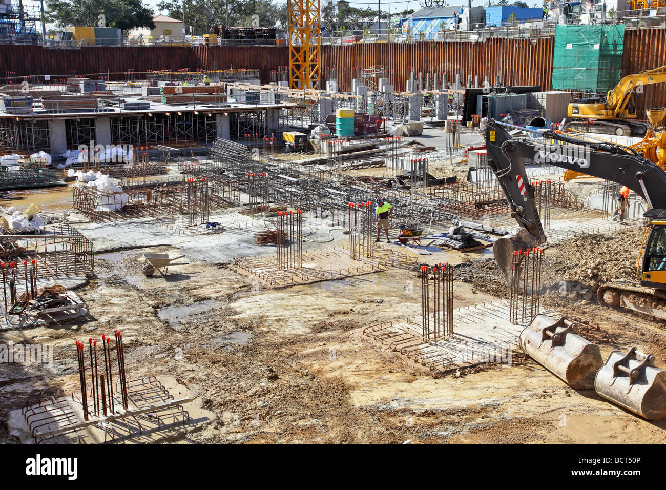 Constructing the concrete and steel foundations for a highrise building ...
