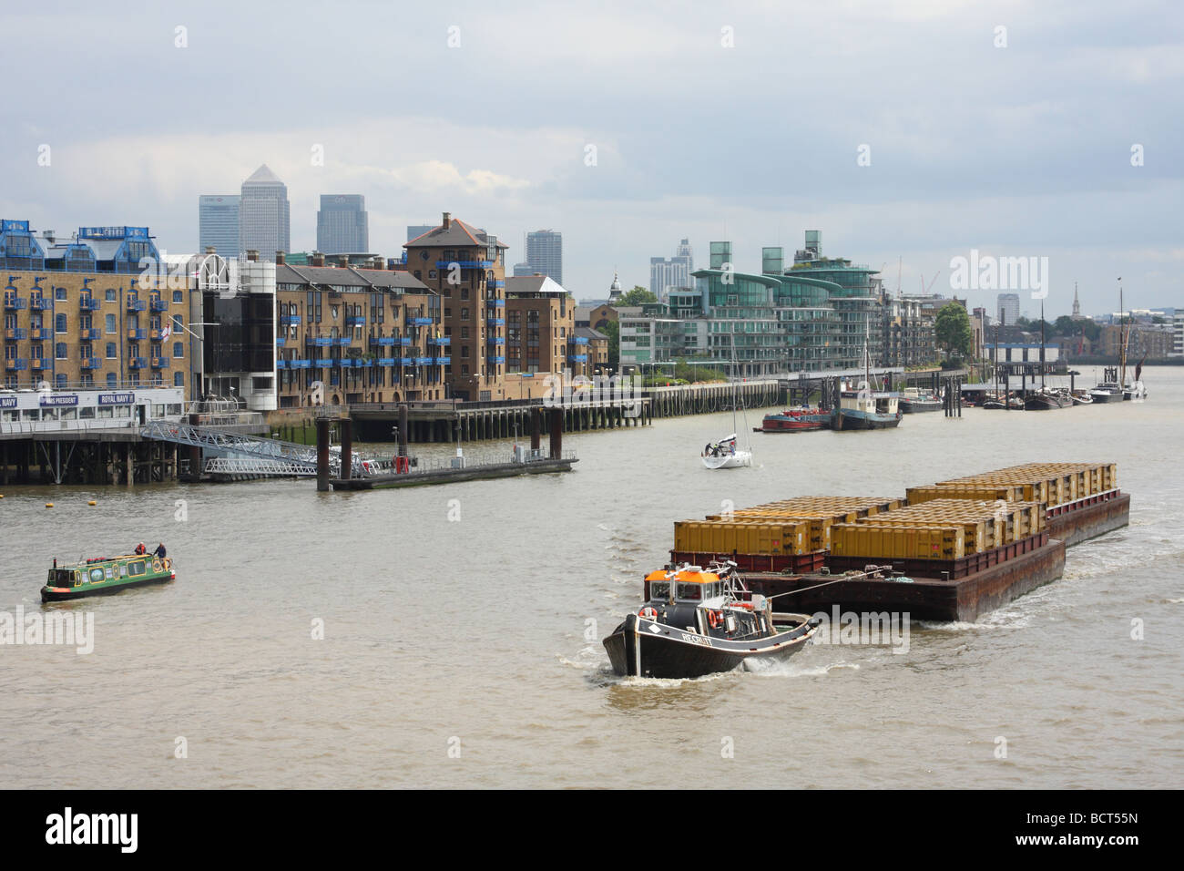 Cargo barges transporting containers on the River Thames at Tower ...
