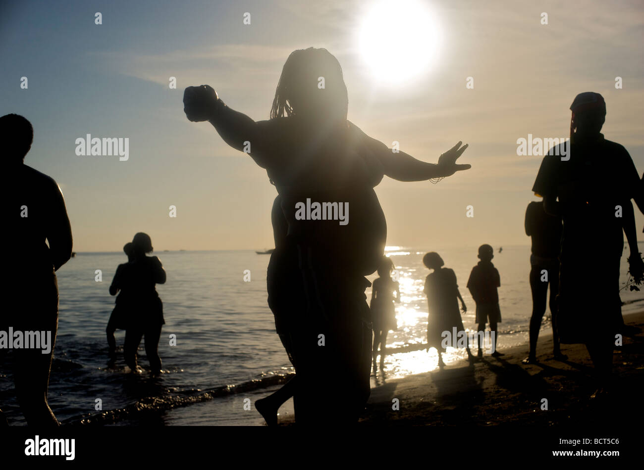 Silhouetted pilgrims dance during a sunrise voodoo ritual at Bord de ...