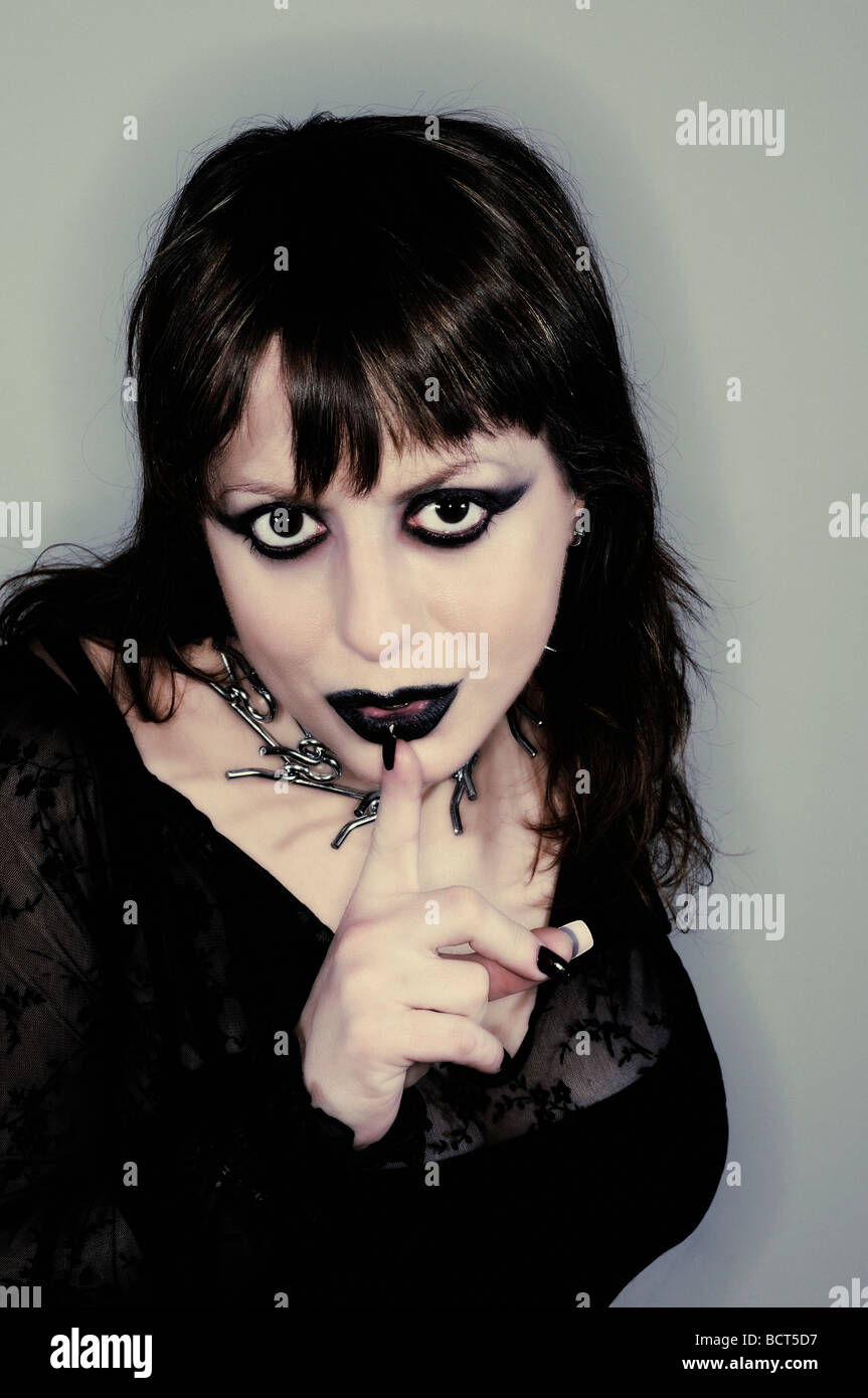 Studio portrait of a young woman in dark look Stock Photo - Alamy