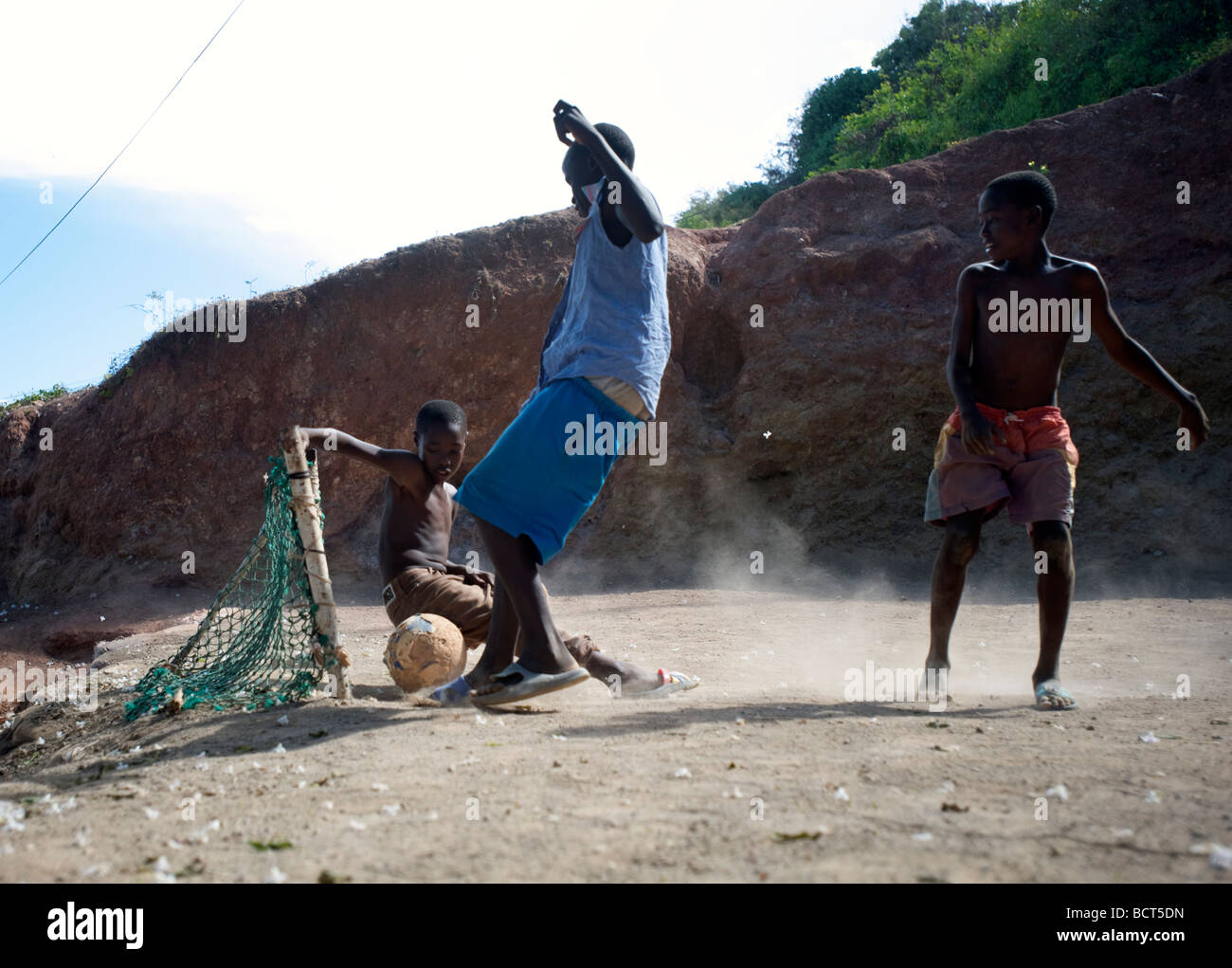 Children play a game of football (soccer) in the Carenage neighborhood ...