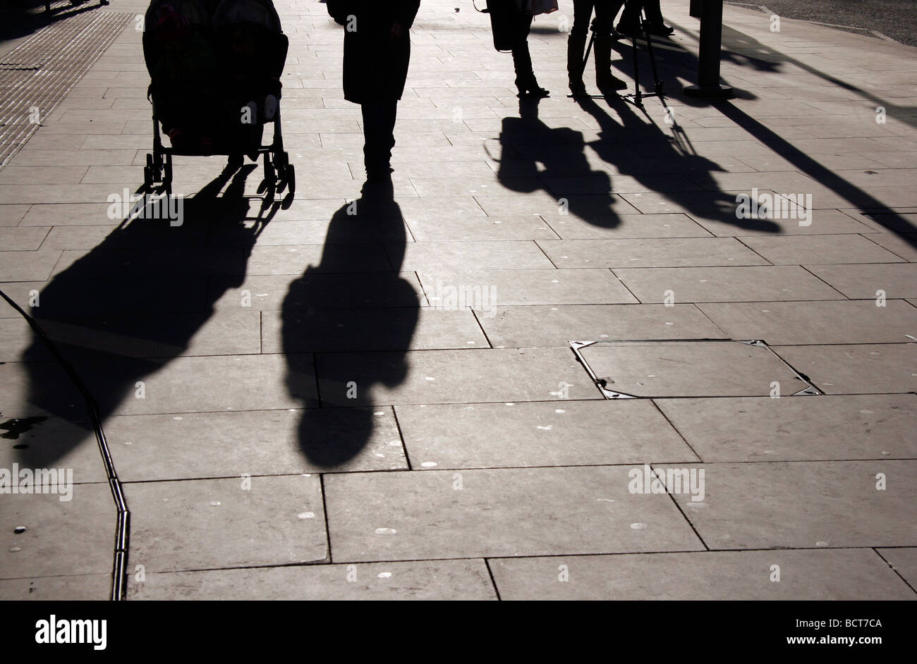 long shadows of people walking in the UK Stock Photo - Alamy