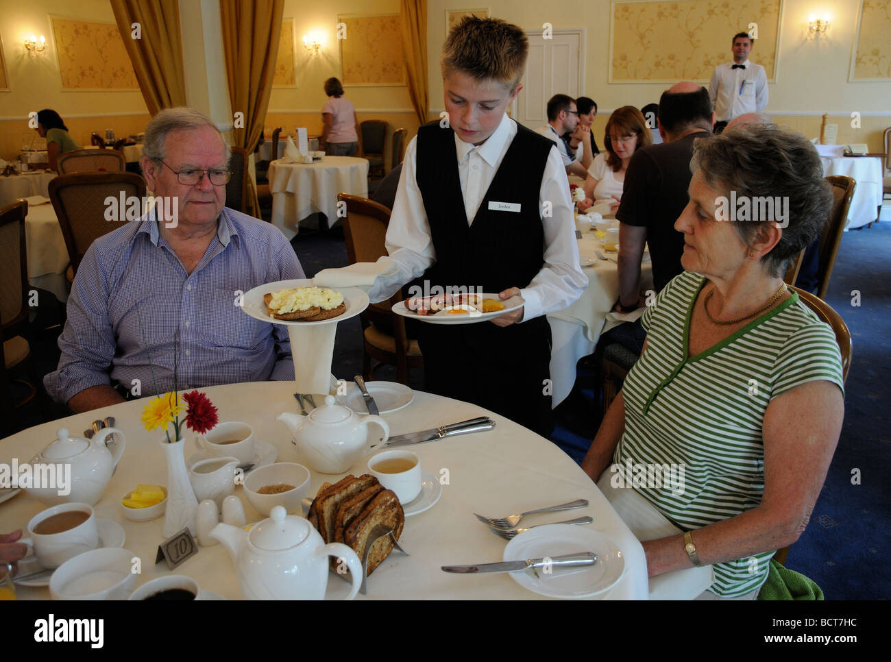 Work experience student serving breakfast in a hotel restaurant Stock ...