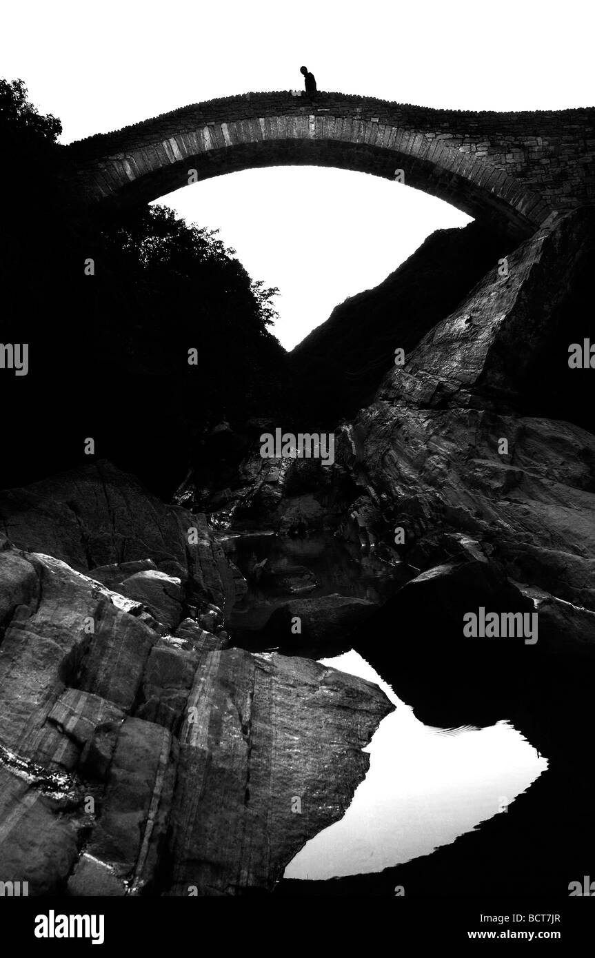 Man passing on a bridge over the river Stock Photo - Alamy