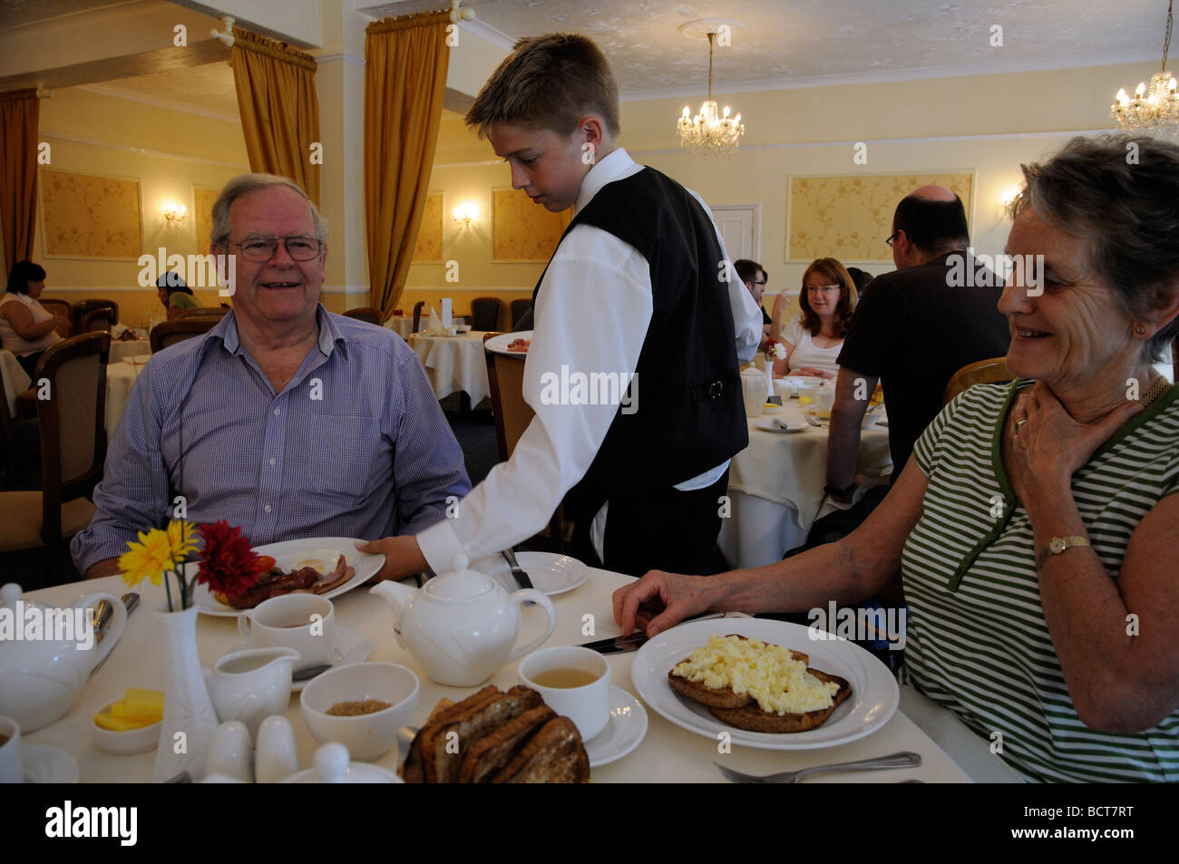 Work experience student serving breakfast in a hotel restaurant Stock ...