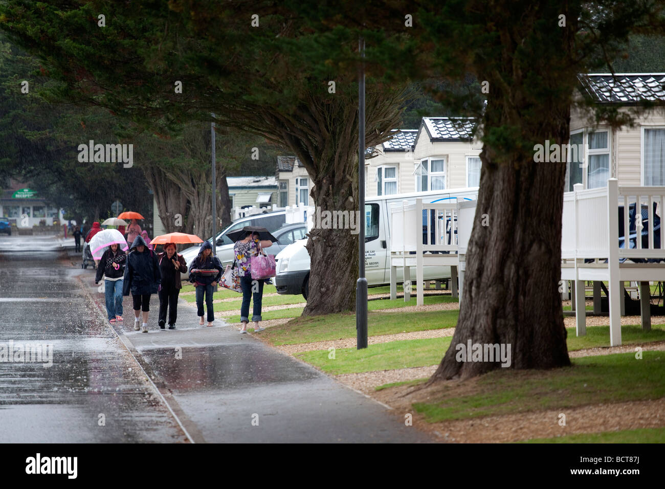 Holiday makers brave the rain during their holiday on a British Caravan ...
