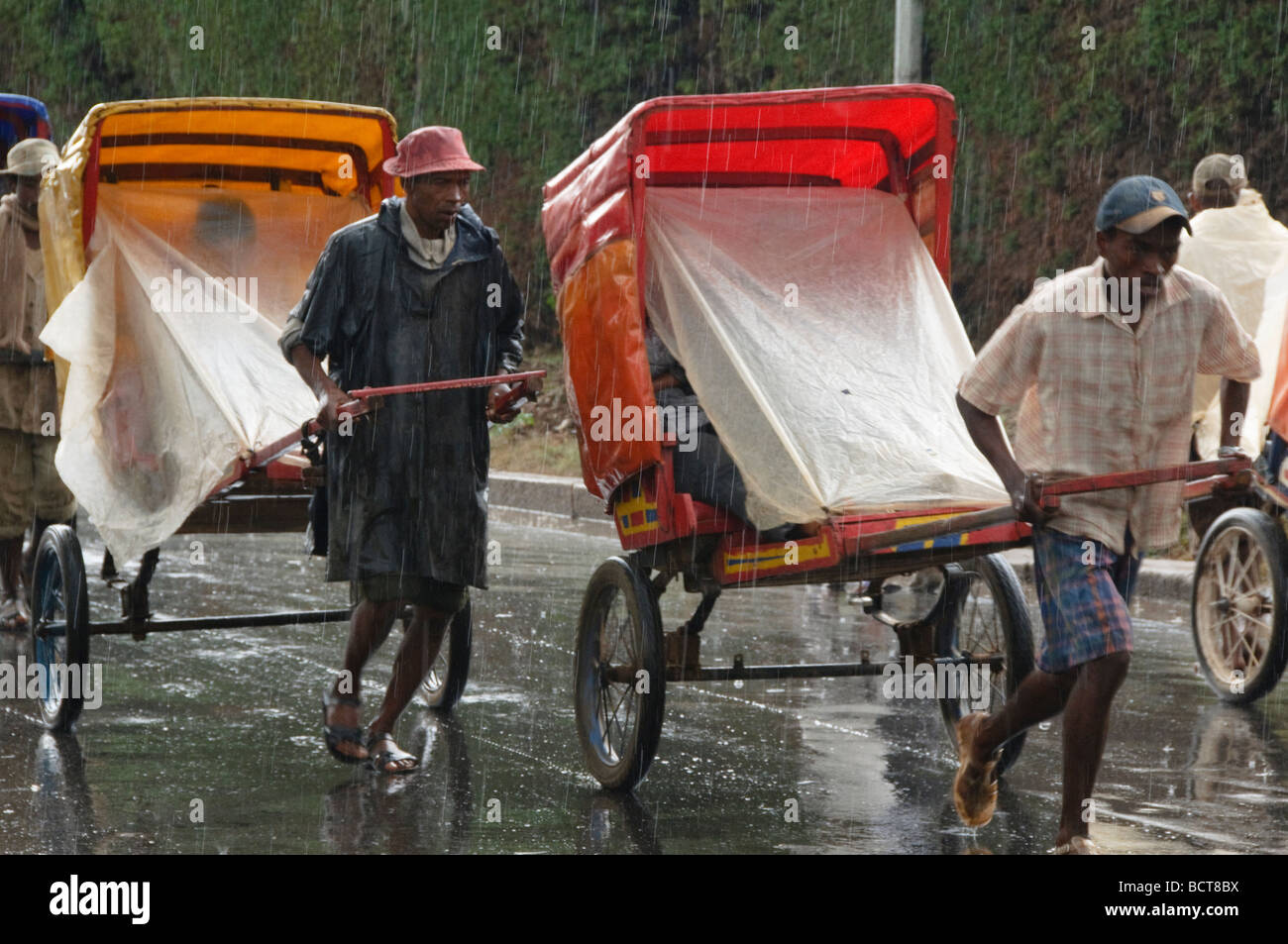 pousse pousse drivers in the rain in Antisirabe Madagascar Stock Photo ...
