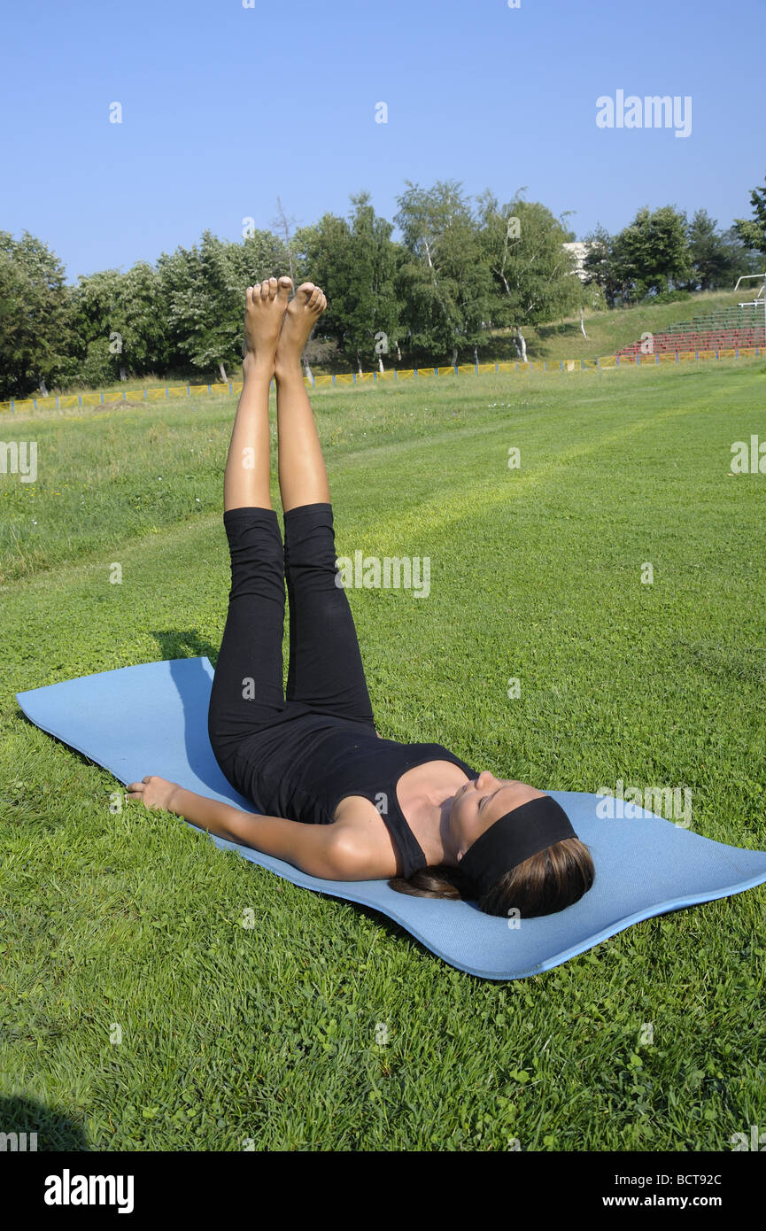 Girl doing advanced stretching exercises for the legs and groin with ...