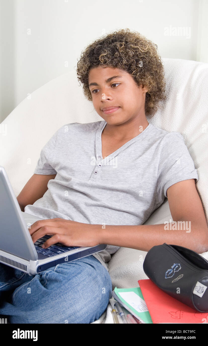 mixed race black teenage boy on his laptop computer Stock Photo - Alamy