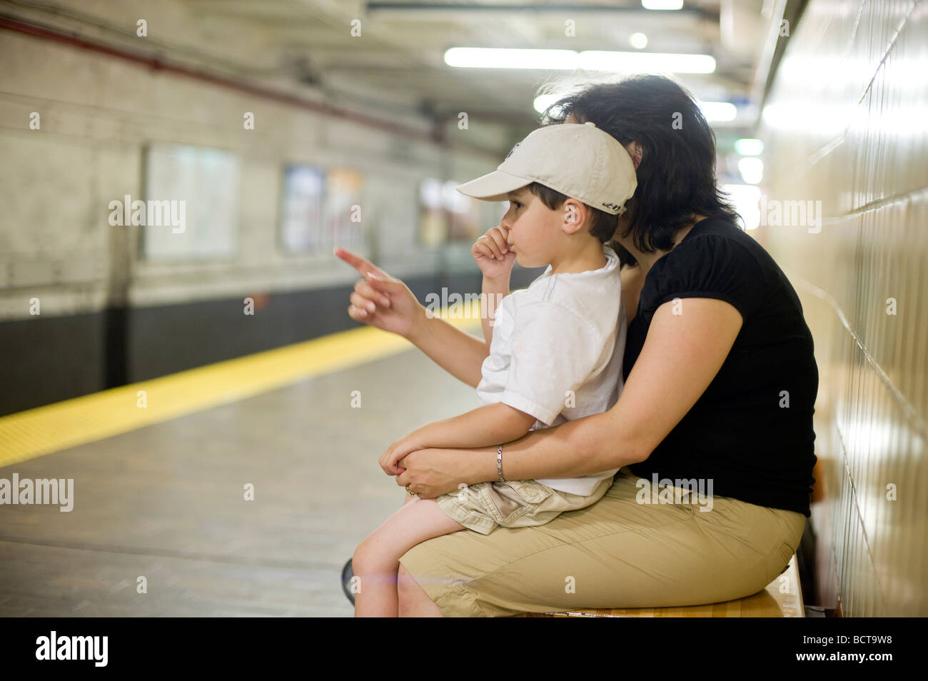 Hispanic mother and three and a half (3 1/2) year old son wait for the ...