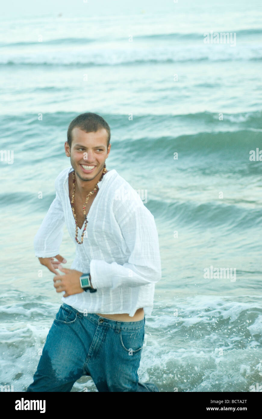 young man running by the sea shore Stock Photo - Alamy
