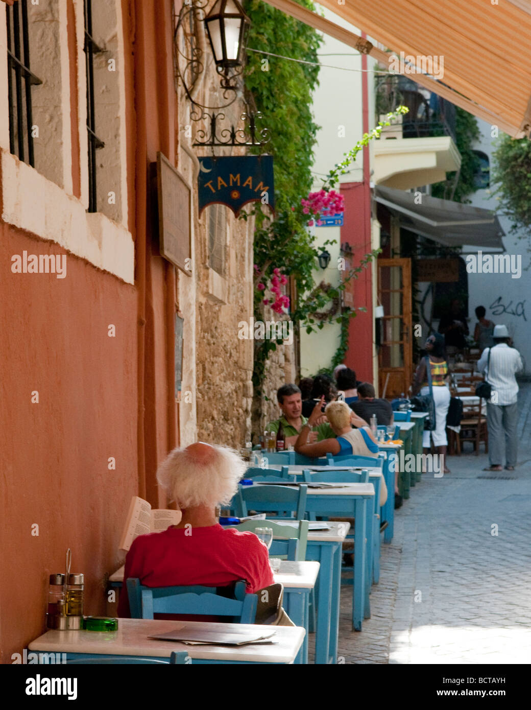 Tourists sitting at outdoor Taverna in the Old Town. Chania, Crete ...