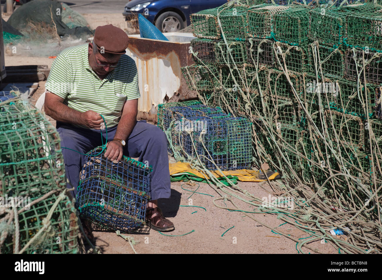 Portuguese Man mending fish traps in Lagos, Portugal Stock Photo - Alamy