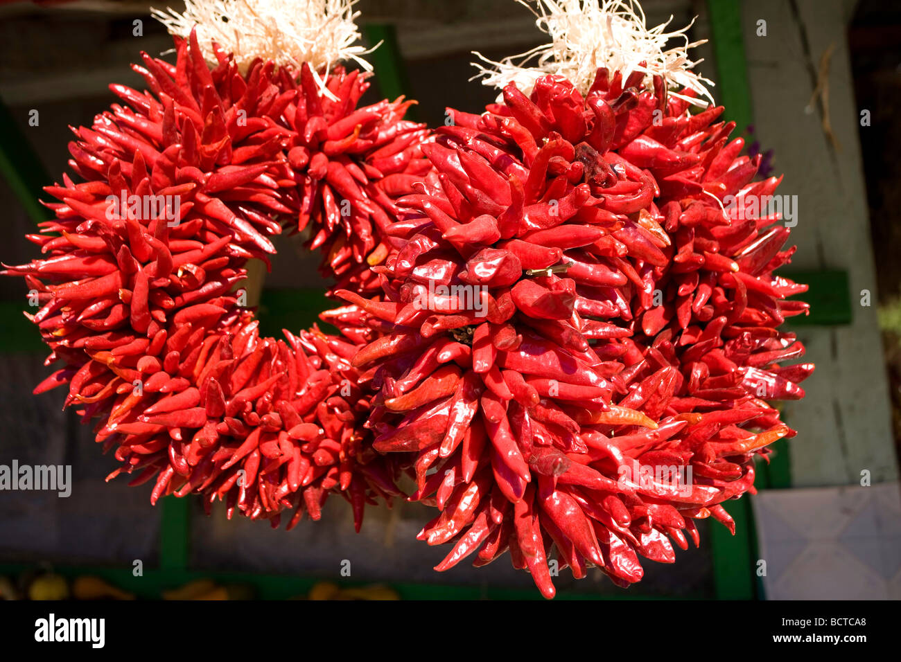 Wreaths of dried red chilies decorate a road side stand near Taos New ...