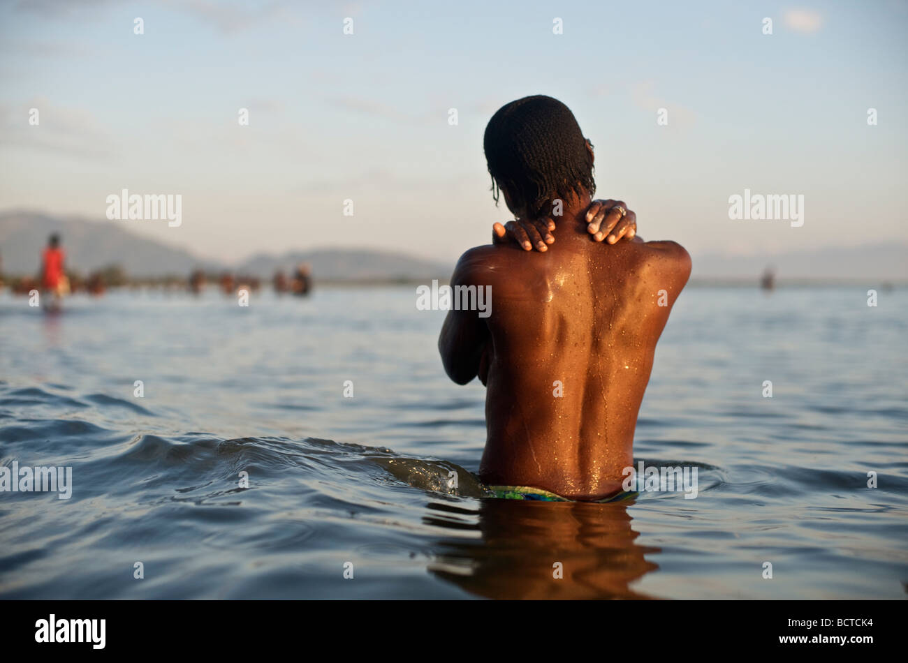 A pilgrim cleanses herself in the sea during a sunrise voodou ritual at ...