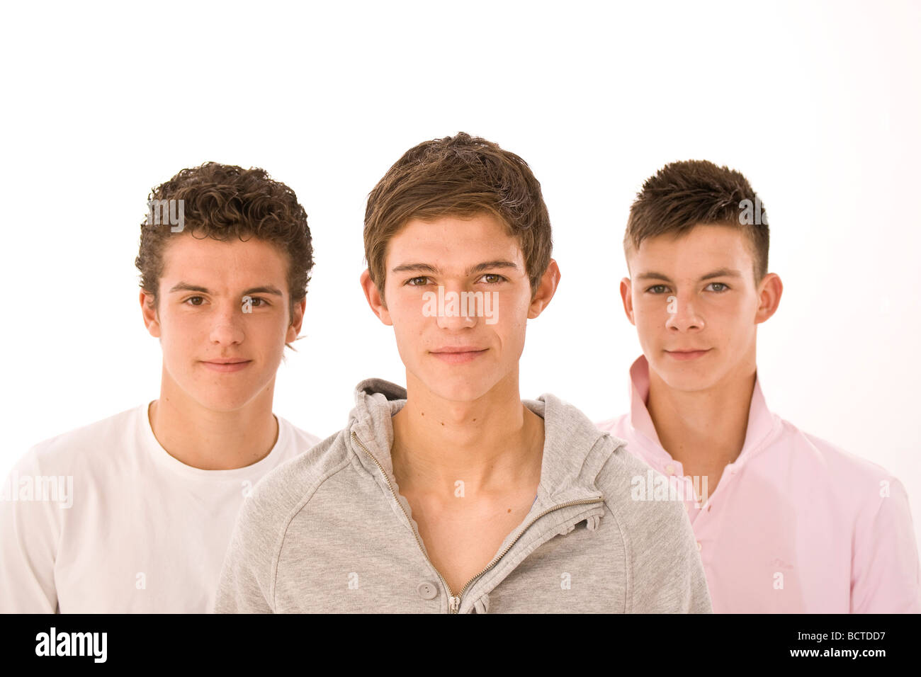 Three boys standing next to each other Stock Photo - Alamy