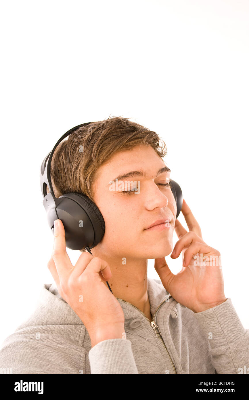 Boy listening to music on headphones Stock Photo - Alamy