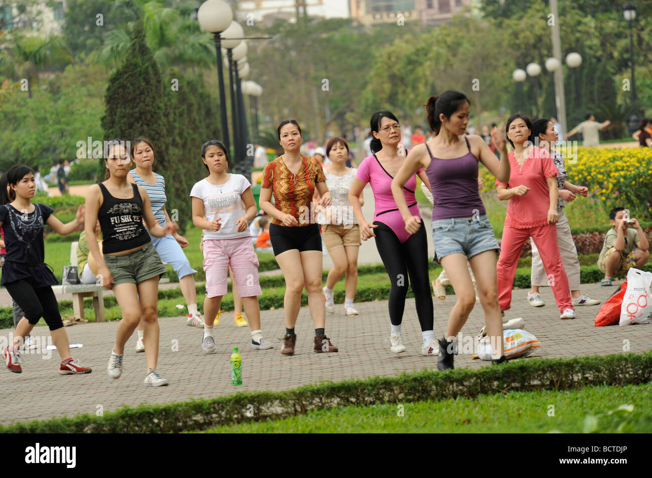 group of vietnamese ladies doing aerobic dancing in the park, Hanoi ...