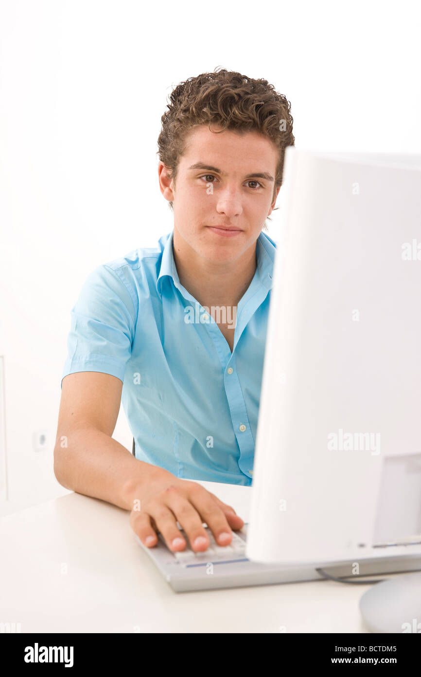 Boy smiling, working on his computer Stock Photo - Alamy