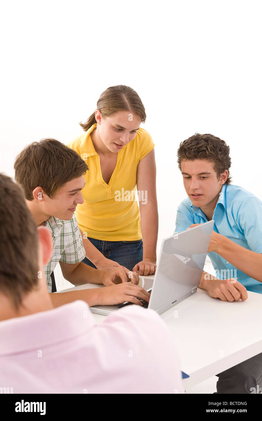 Three boys and a girl working on a computer Stock Photo - Alamy
