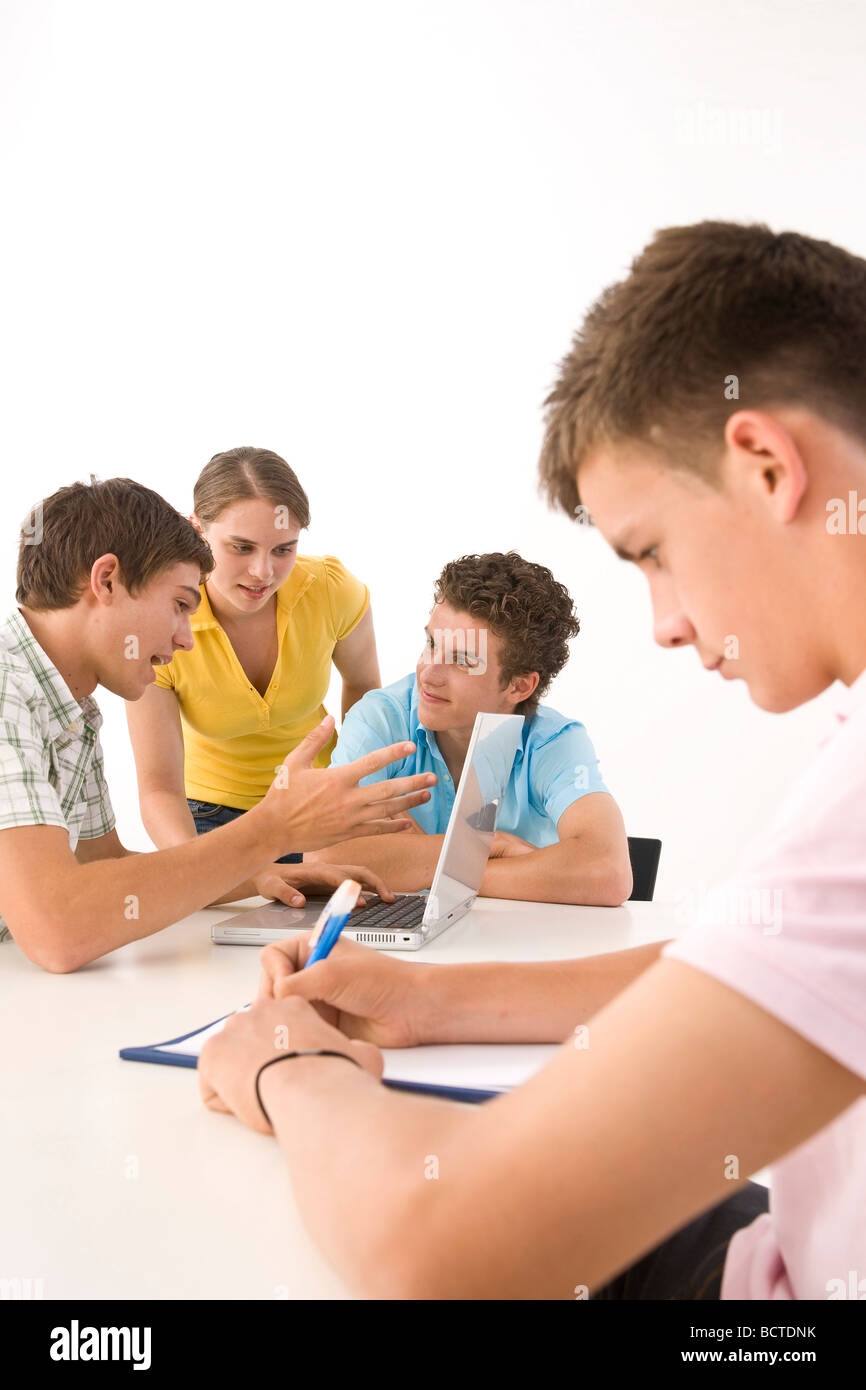 Three boys and a girl working on a computer Stock Photo - Alamy