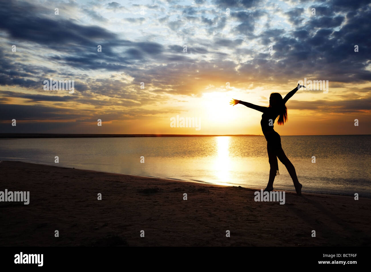 Beautiful sunset and elegant lady making exercise Stock Photo - Alamy