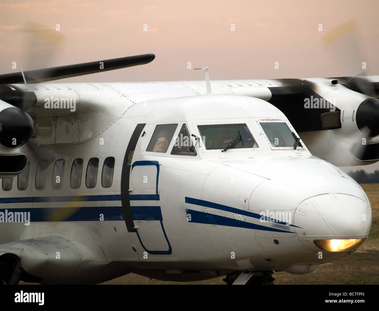 Small turboprop commuter plane close up on sunset Stock Photo - Alamy