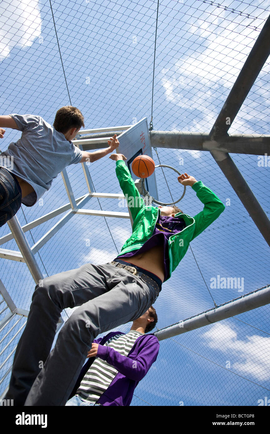 Three boys playing basketball Stock Photo - Alamy