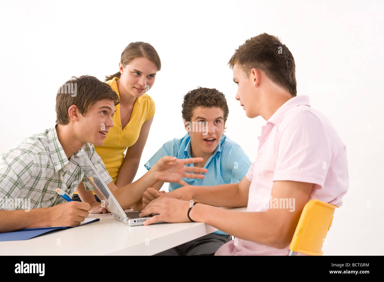 Three boys and a girl working on a computer Stock Photo - Alamy