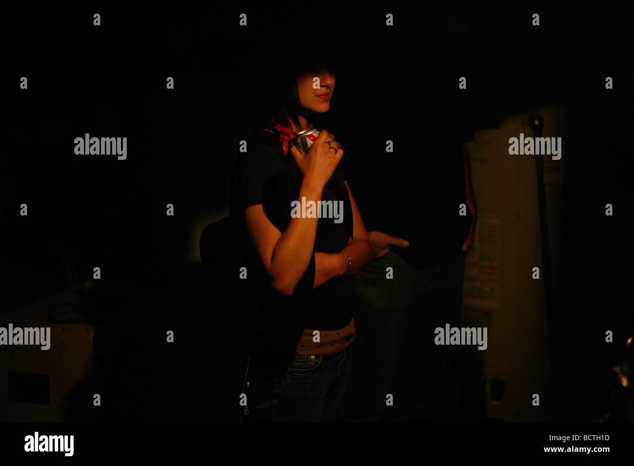 A punk rock girl holds a beer while watching a basement show Stock ...