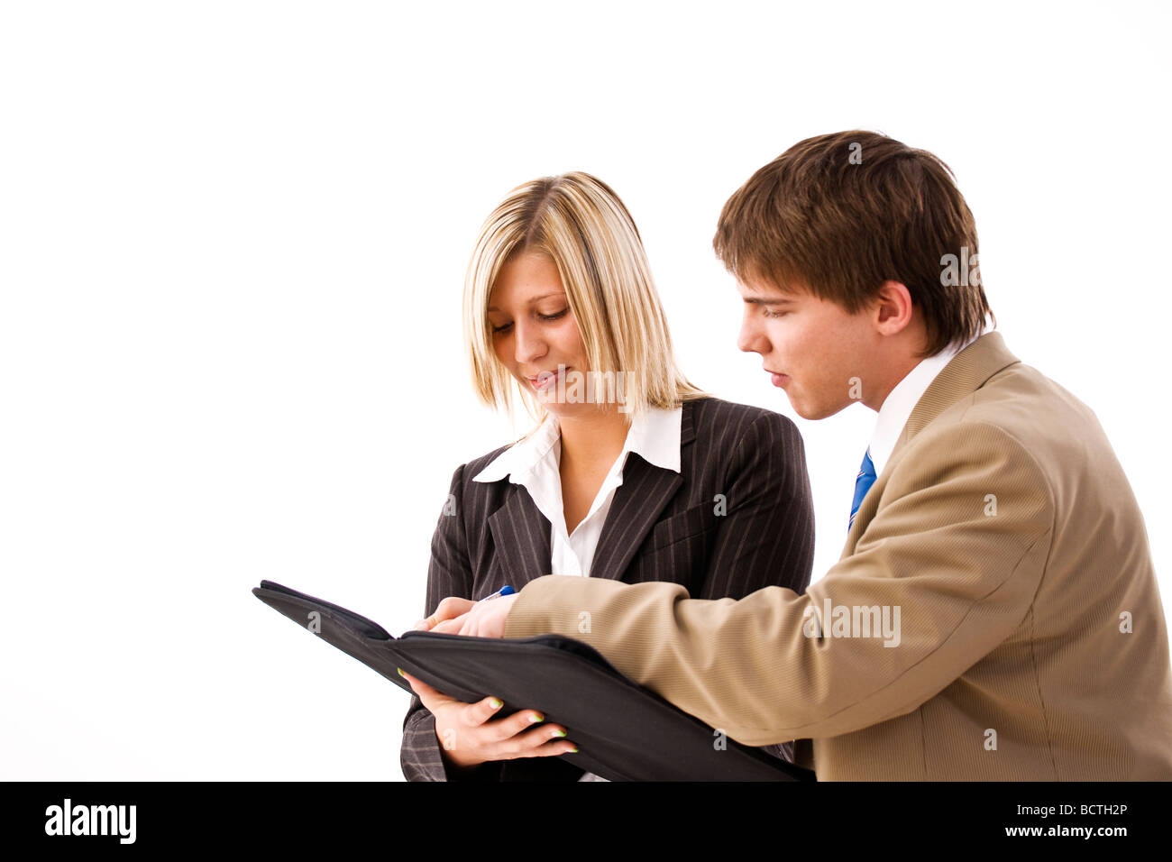 Young manager and secretary checking dates in the appointment calendar ...