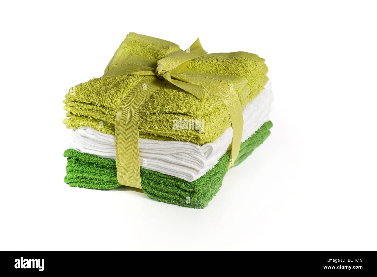Stack of folded washcloths against white background Colors are light ...