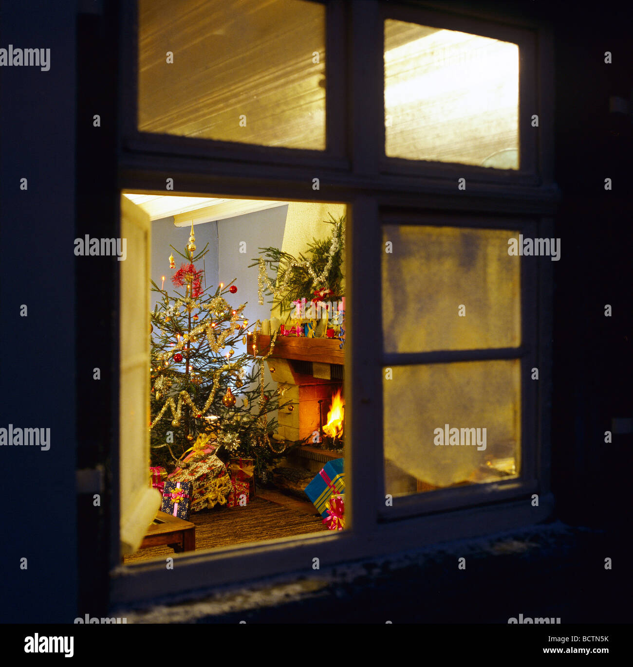 Christmas tree seen through window hi-res stock photography and images ...
